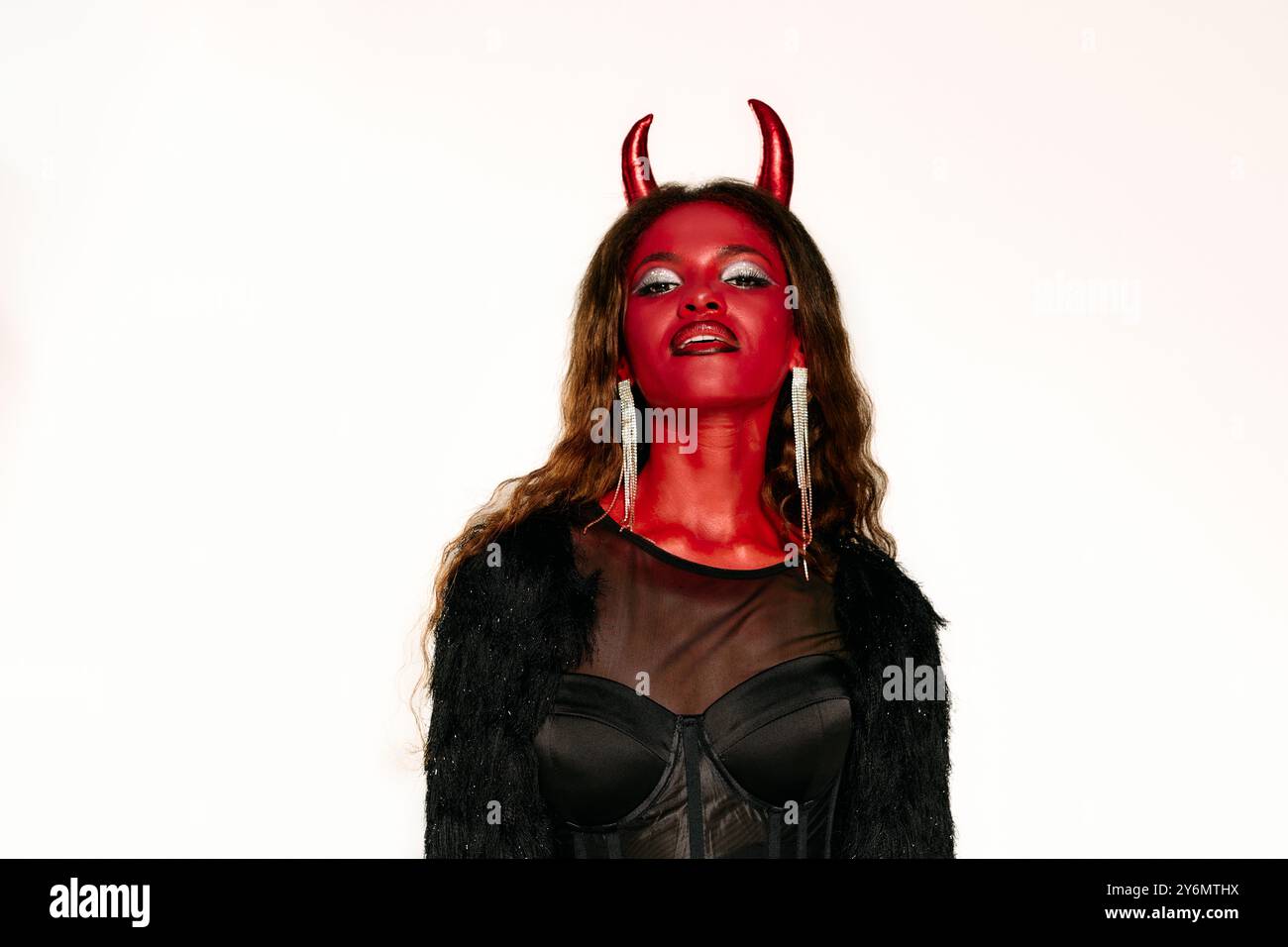 The striking woman dressed as a devil exudes confidence and allure ...