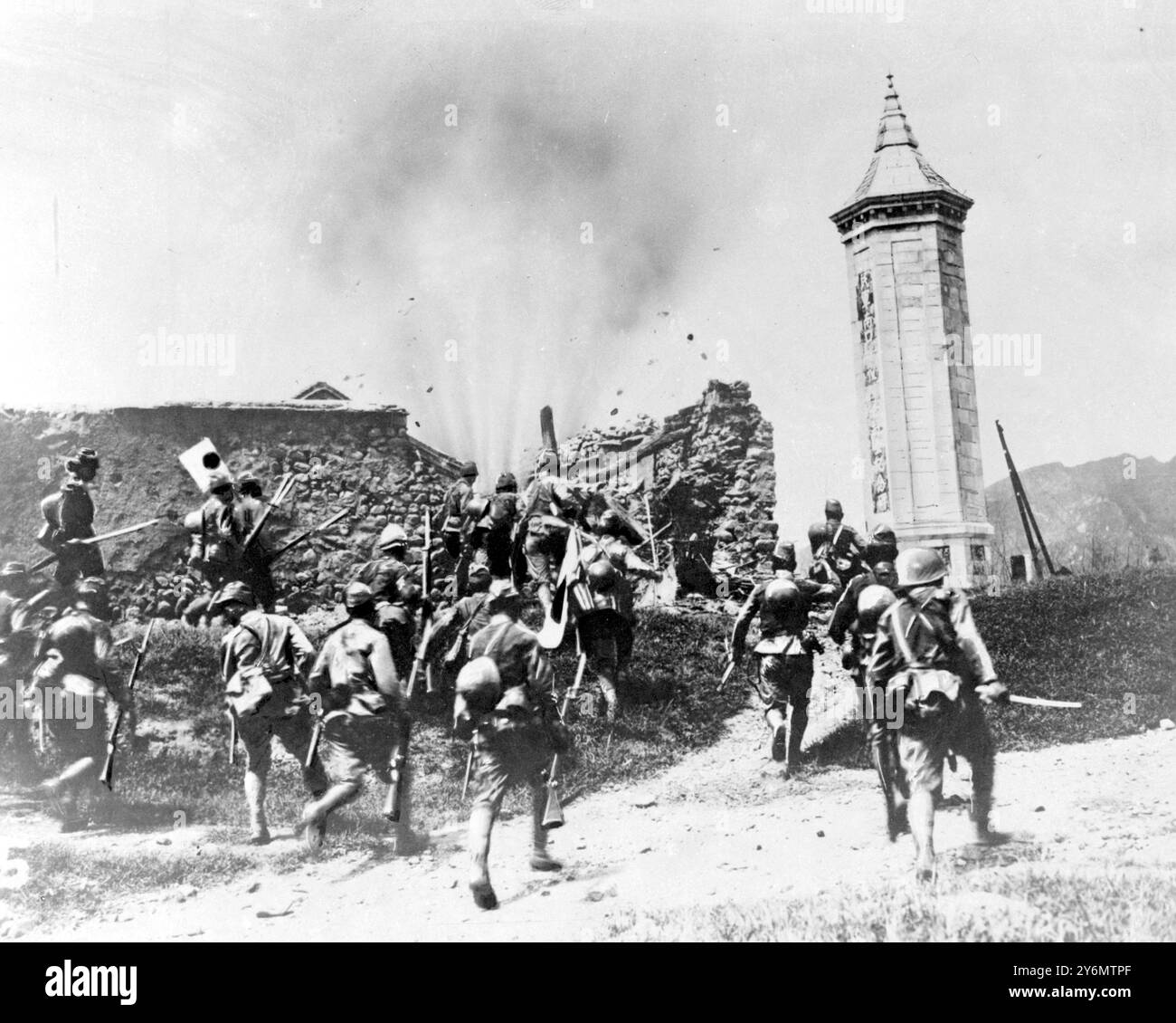 Steel helmeted Japanese troops pressing forward relentlessly as ...