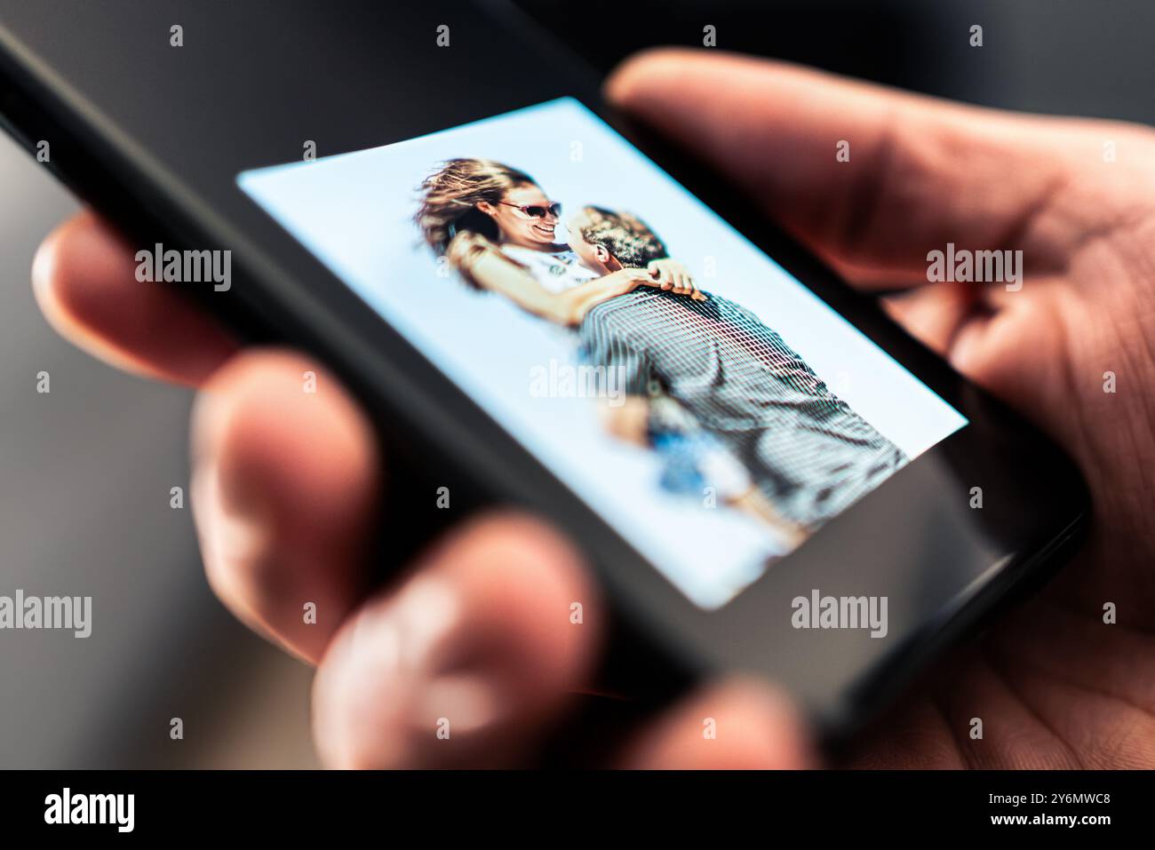 Picture of couple, ex girlfriend in phone. Sad man looking at photos of ...