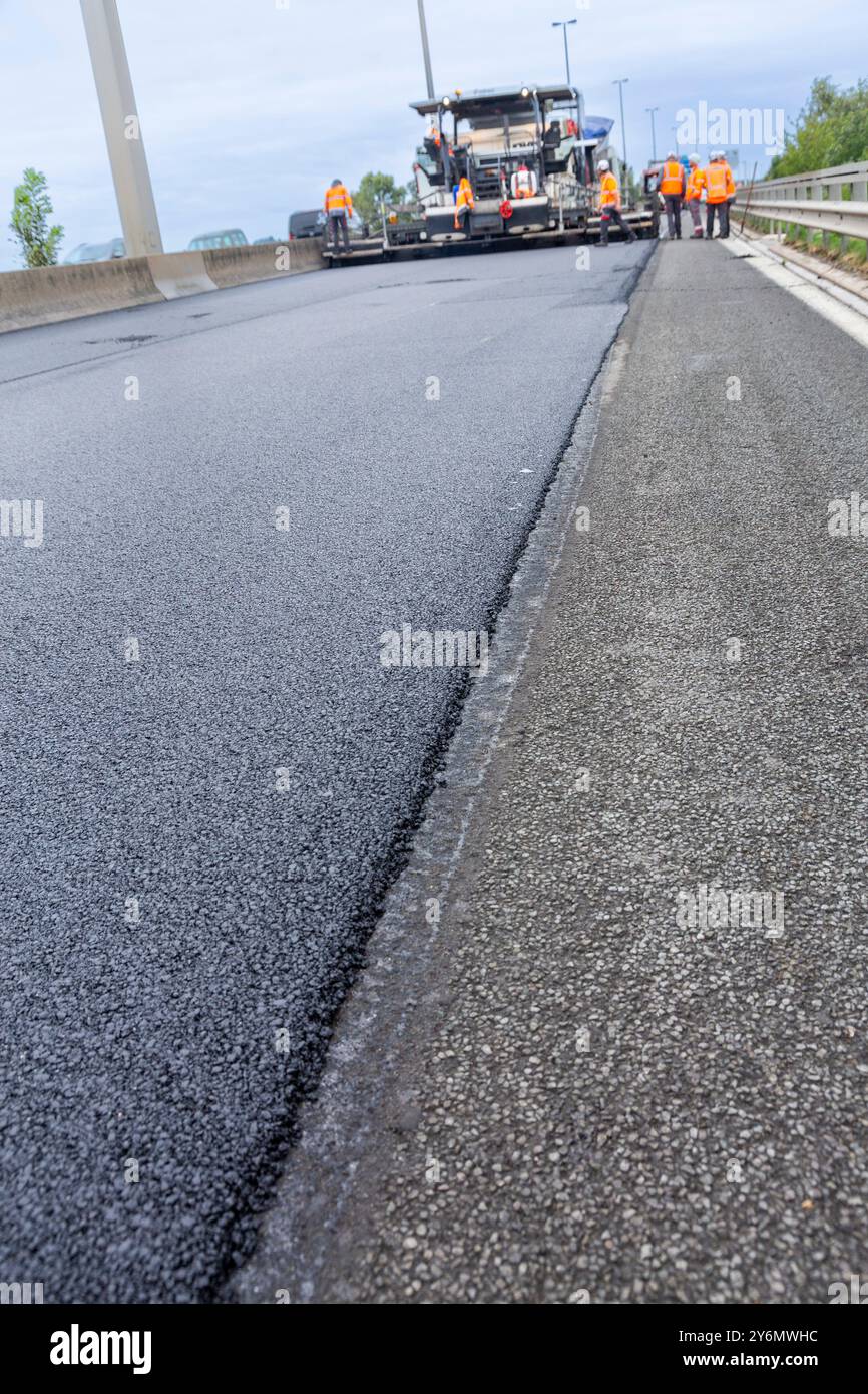 Construction of a bitumen coating on a highway Stock Photo - Alamy