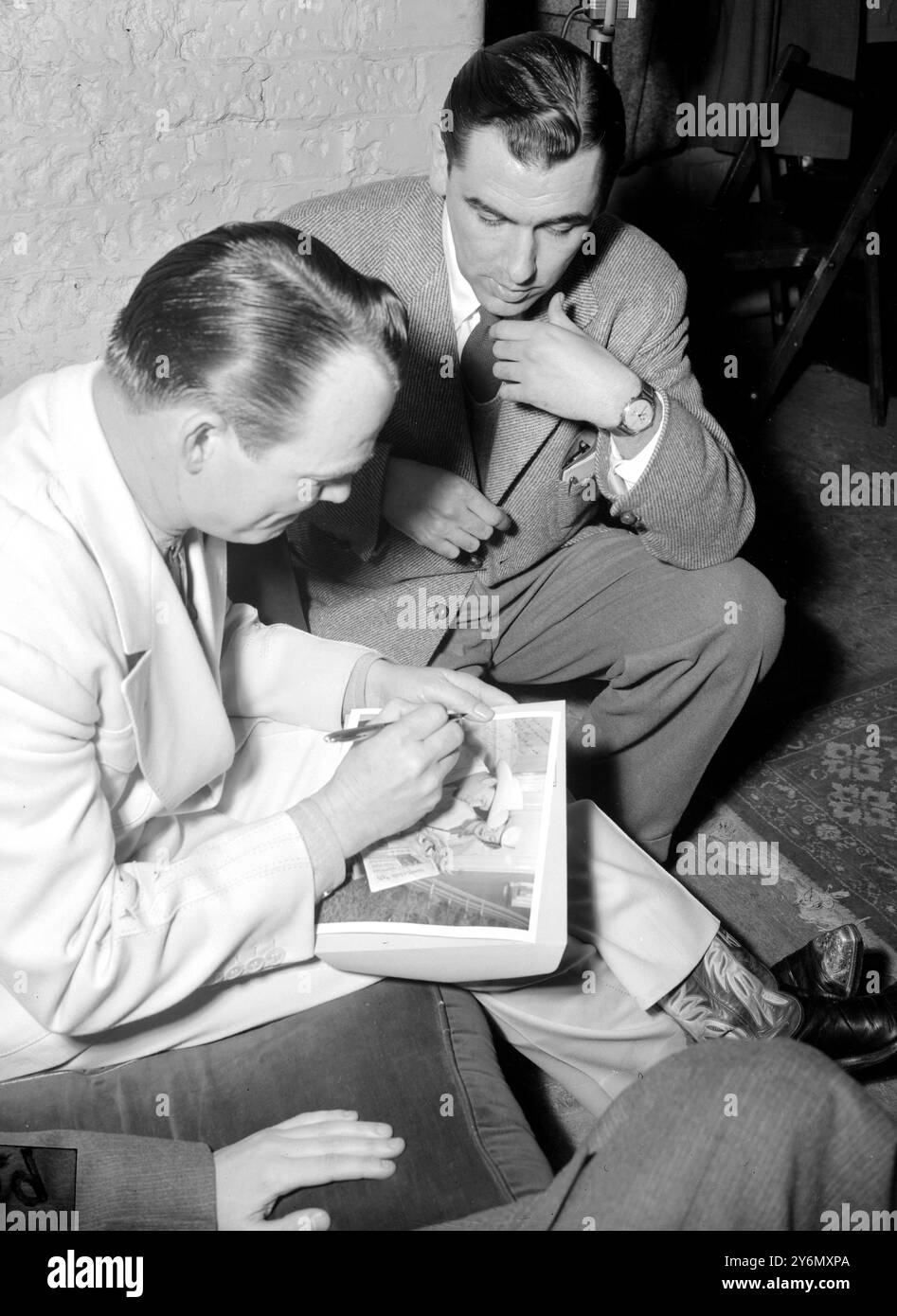 Roy Rogers signs his autograph at Billy Graham meeting Stock Photo - Alamy
