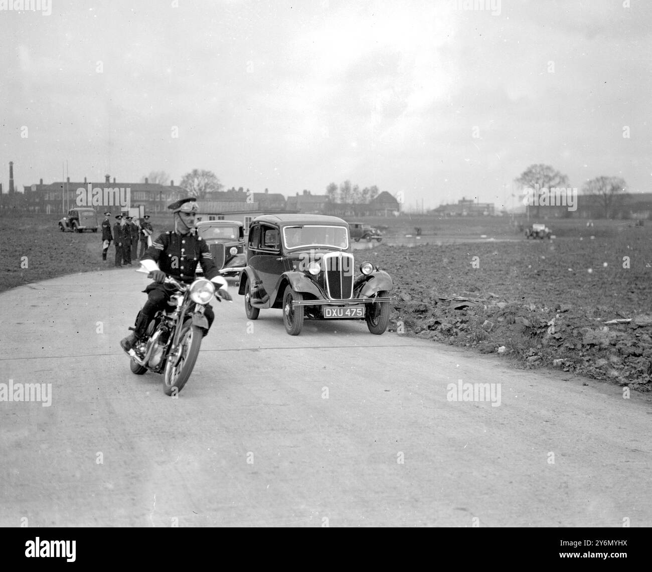 Demonstration at the Police driving school, Hendon. Signalling a driver ...