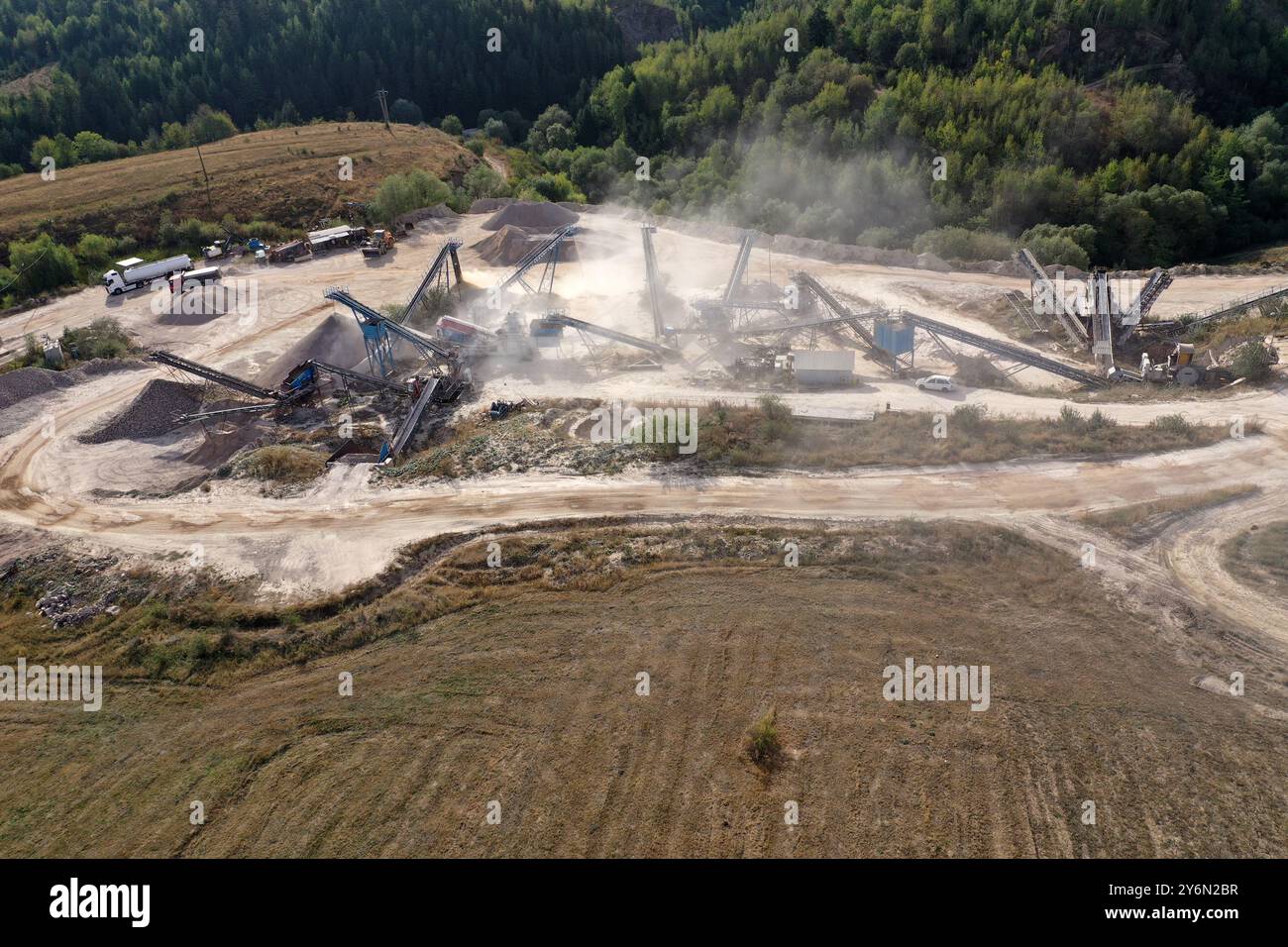 Aerial view of stone quarry conveyor belt system in operation, stone ...