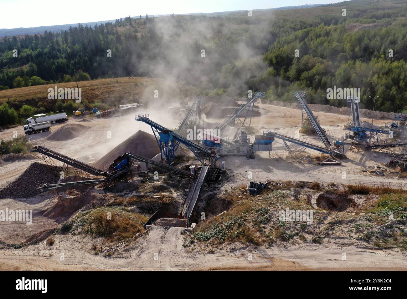Aerial view of an excavator loading crushed stone into a dump truck in ...