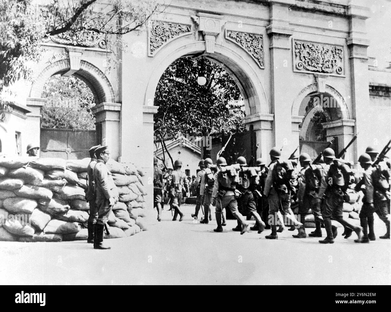 Japanese troops carrying guns and full equipment, marching out of the ...