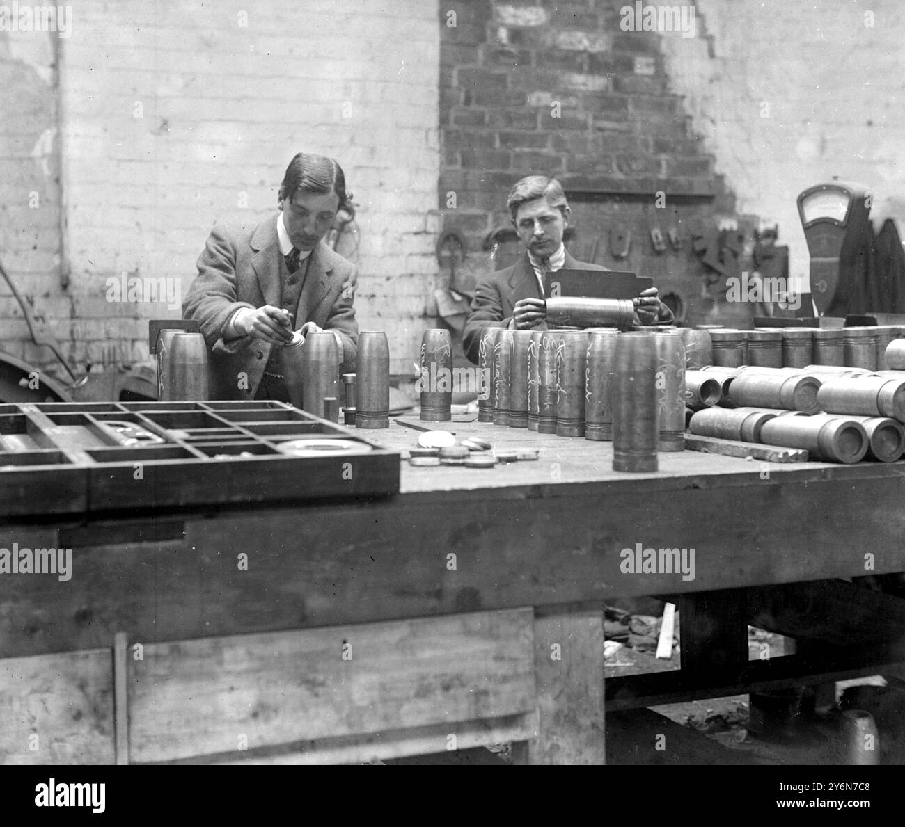 Governent inspectors measuring a shell to tell if sizes are correct ...