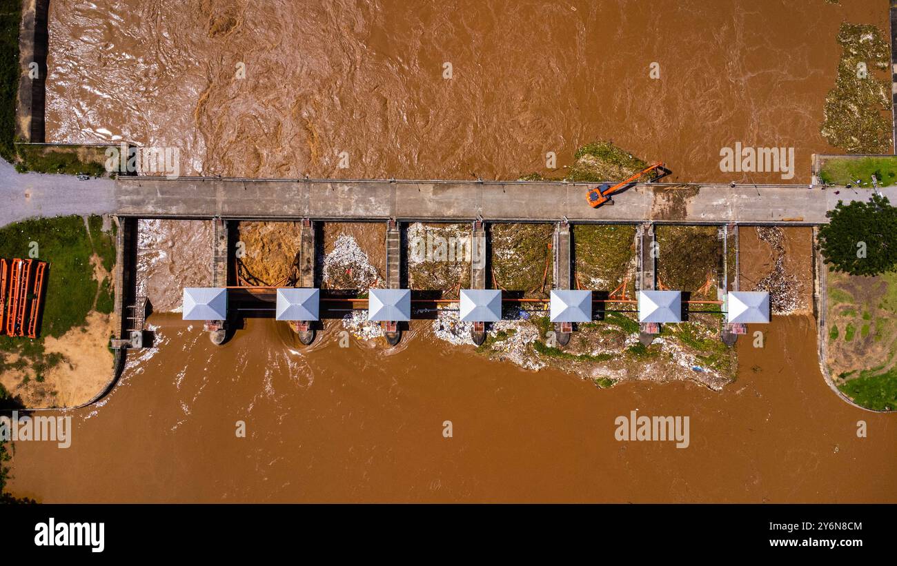 Aerial view of the dam's floodgates with rapid flow of water in the ...