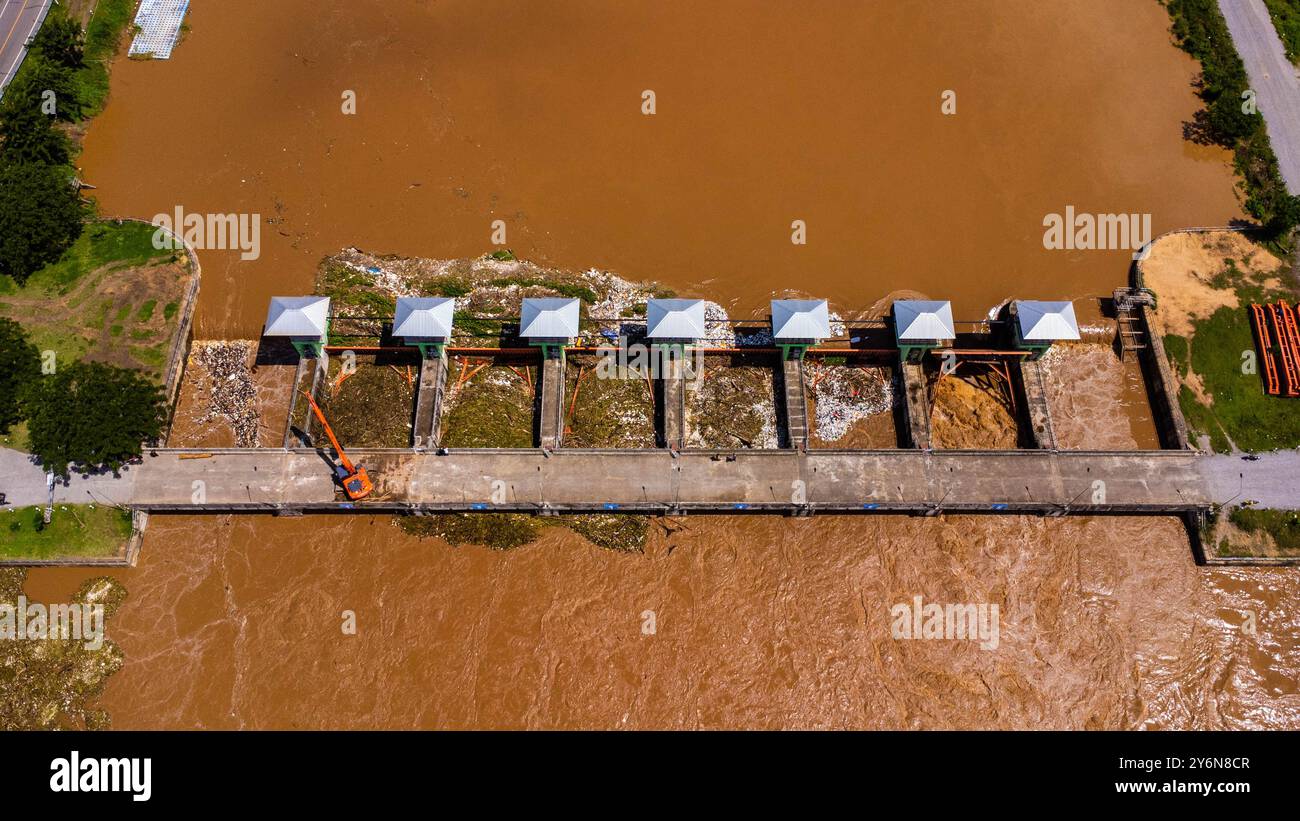 Aerial view of the dam's floodgates with rapid flow of water in the ...