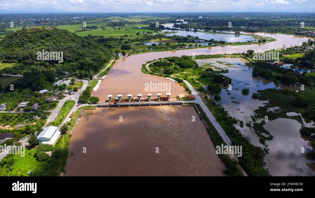 Aerial view of the dam's floodgates with rapid flow of water in the ...