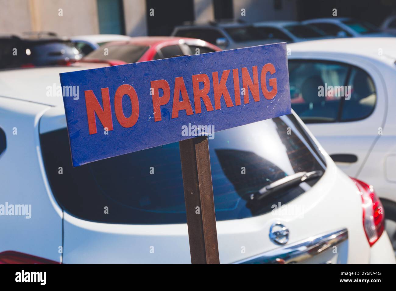 Car parked in front of a No parking sign Stock Photo - Alamy