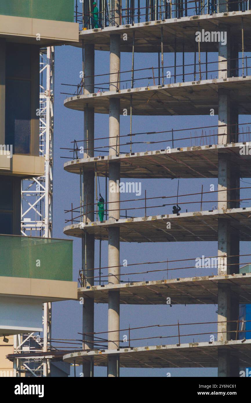 United Arab Emirates, Dubai, Deira district. Workers on a building ...