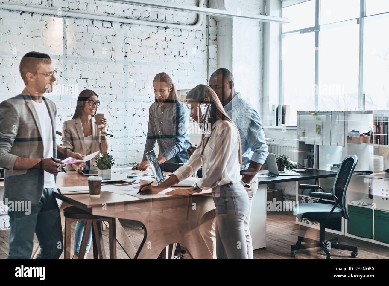 Business team standing behind glass hi-res stock photography and images ...