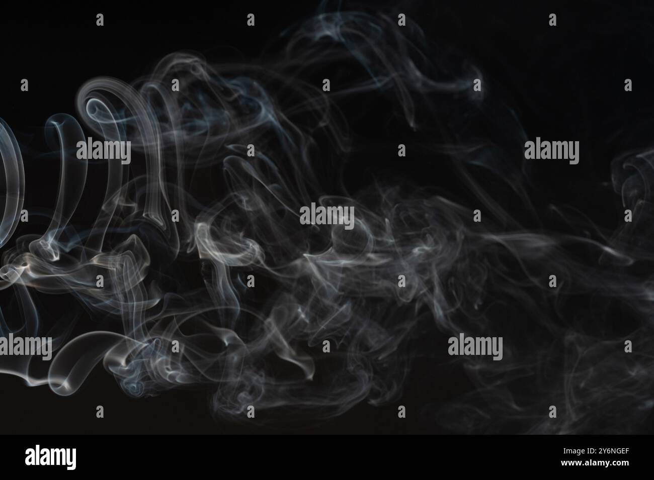 Smoke blow swirl line on black studio background Stock Photo - Alamy