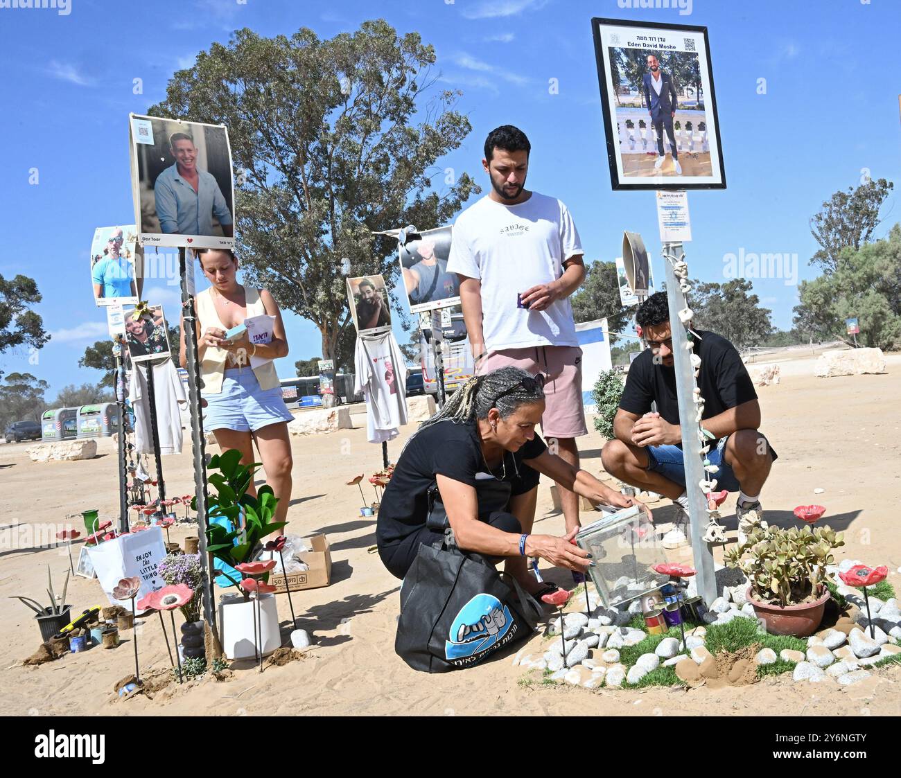 Vera Moshe knees by the memorial for her son Eden David Moshe, 27, who ...