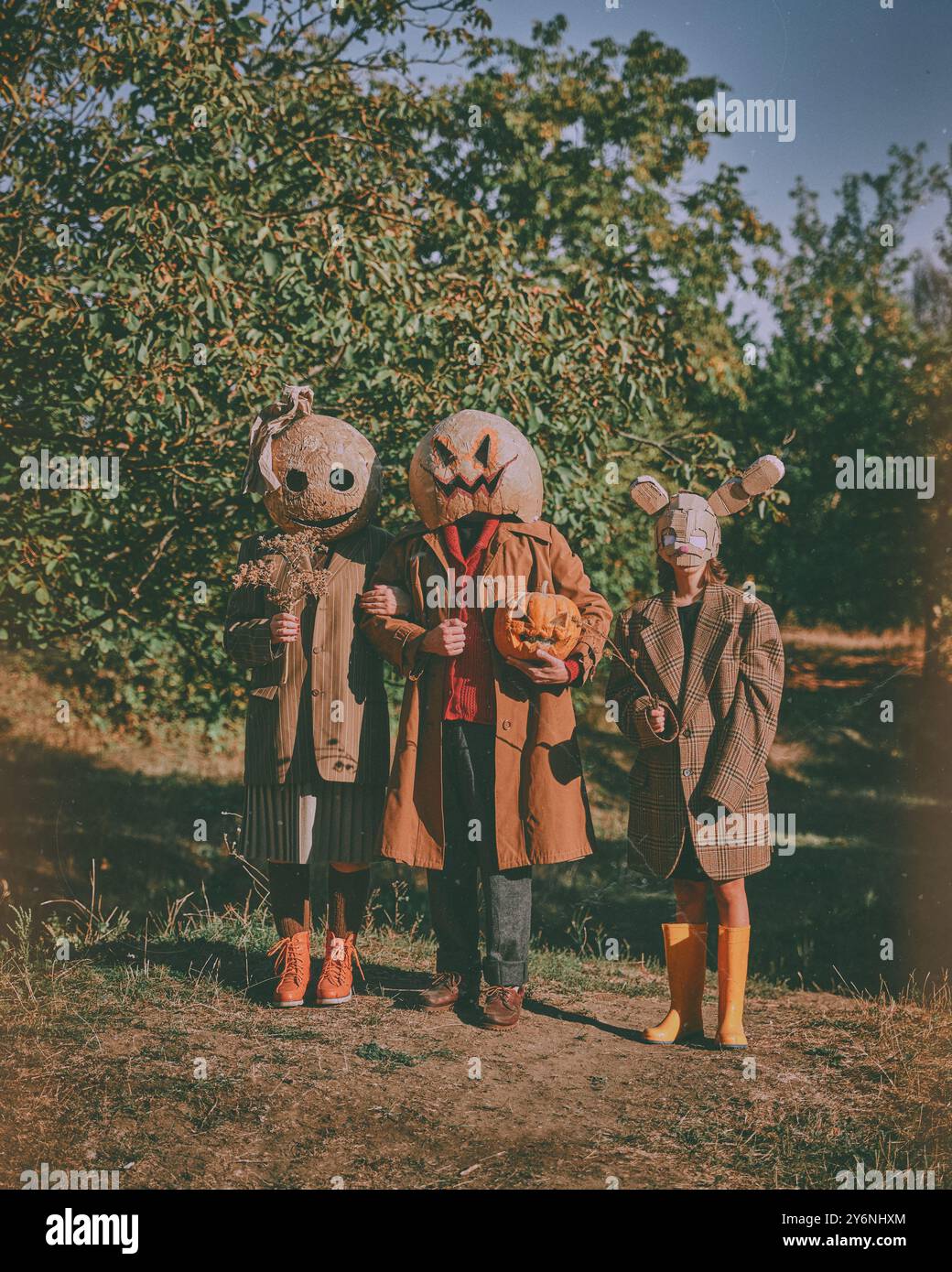 Three spooky figures standing in sunlight, with creepy pumpkin and ...