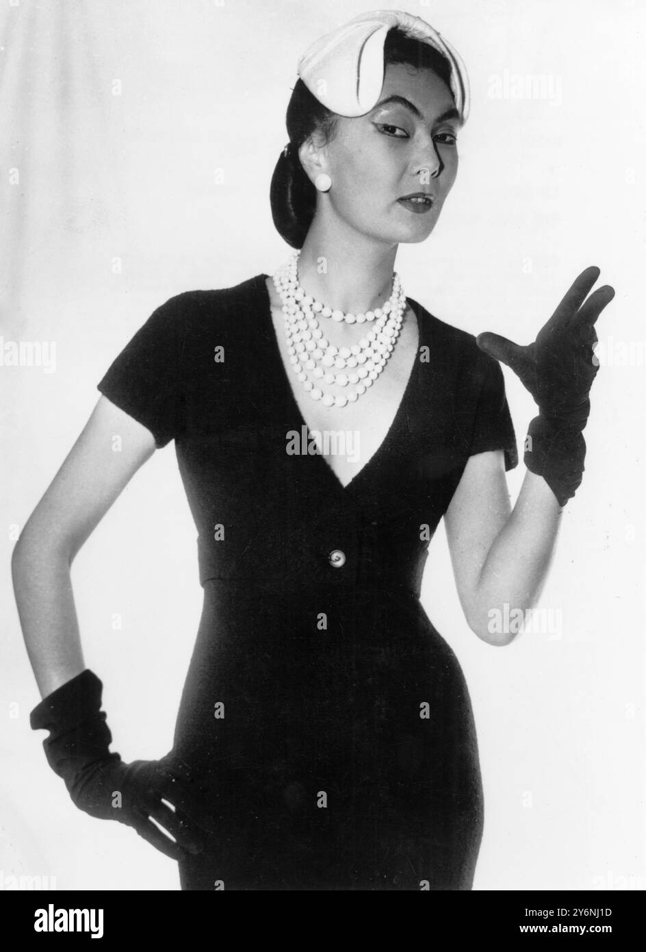 Decollete - by Christian Dior A simple black crepe short cocktail dress ...