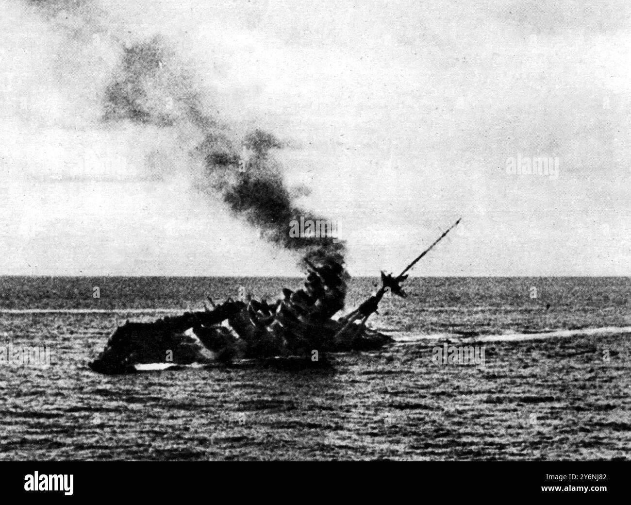 Immediately after being hit by a salvo of torpedoes, HMS Barham heavily ...