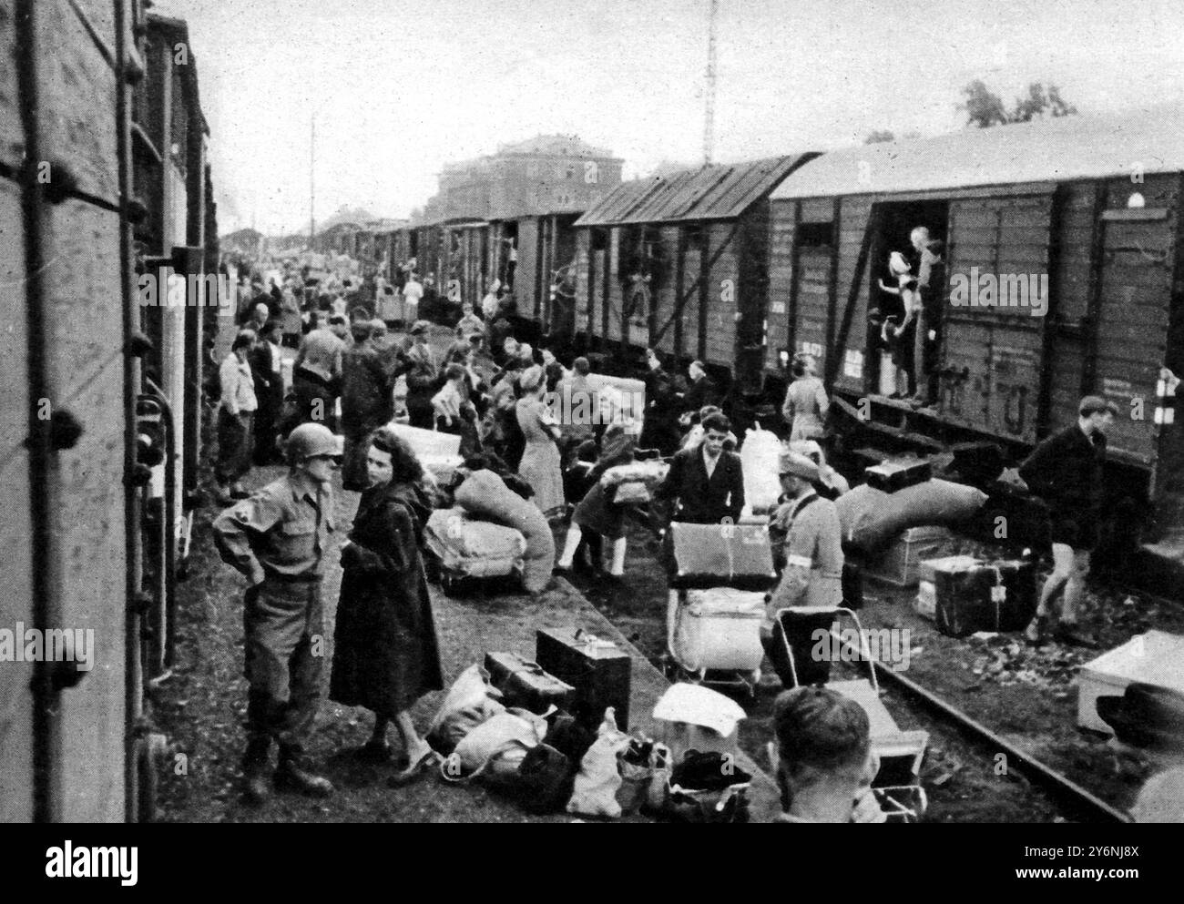 A scene common in Europe today, crowds of refugees waiting for one of ...