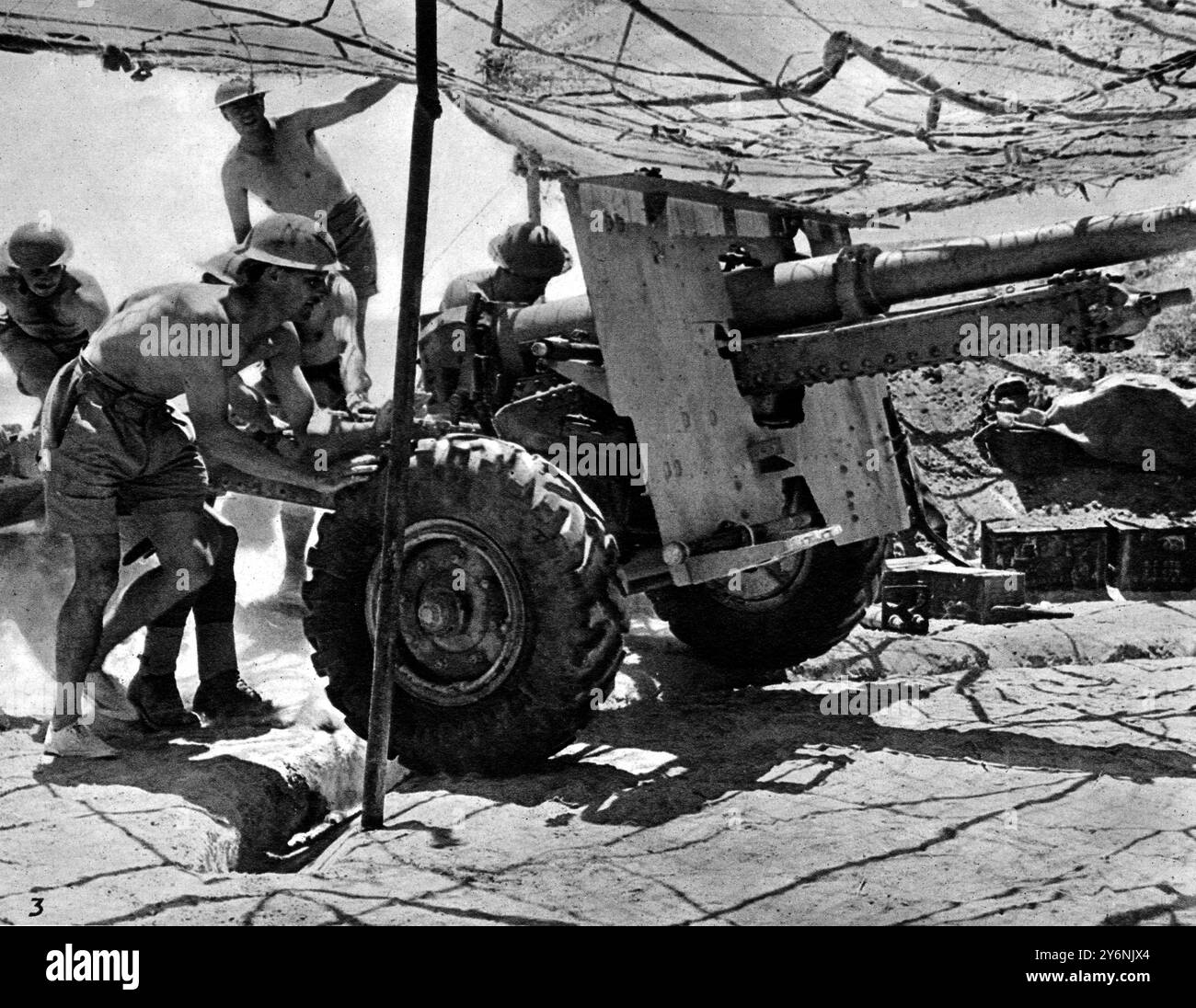 Pushing a 25 pounder Howitzer gun into a forward position August 1942 ...