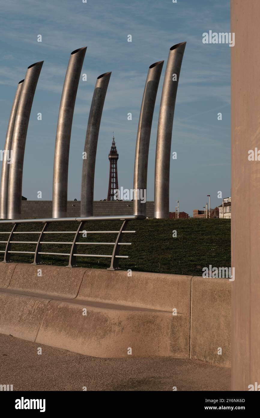 Modern metallic spires rise against the sky, framing a distant historic ...