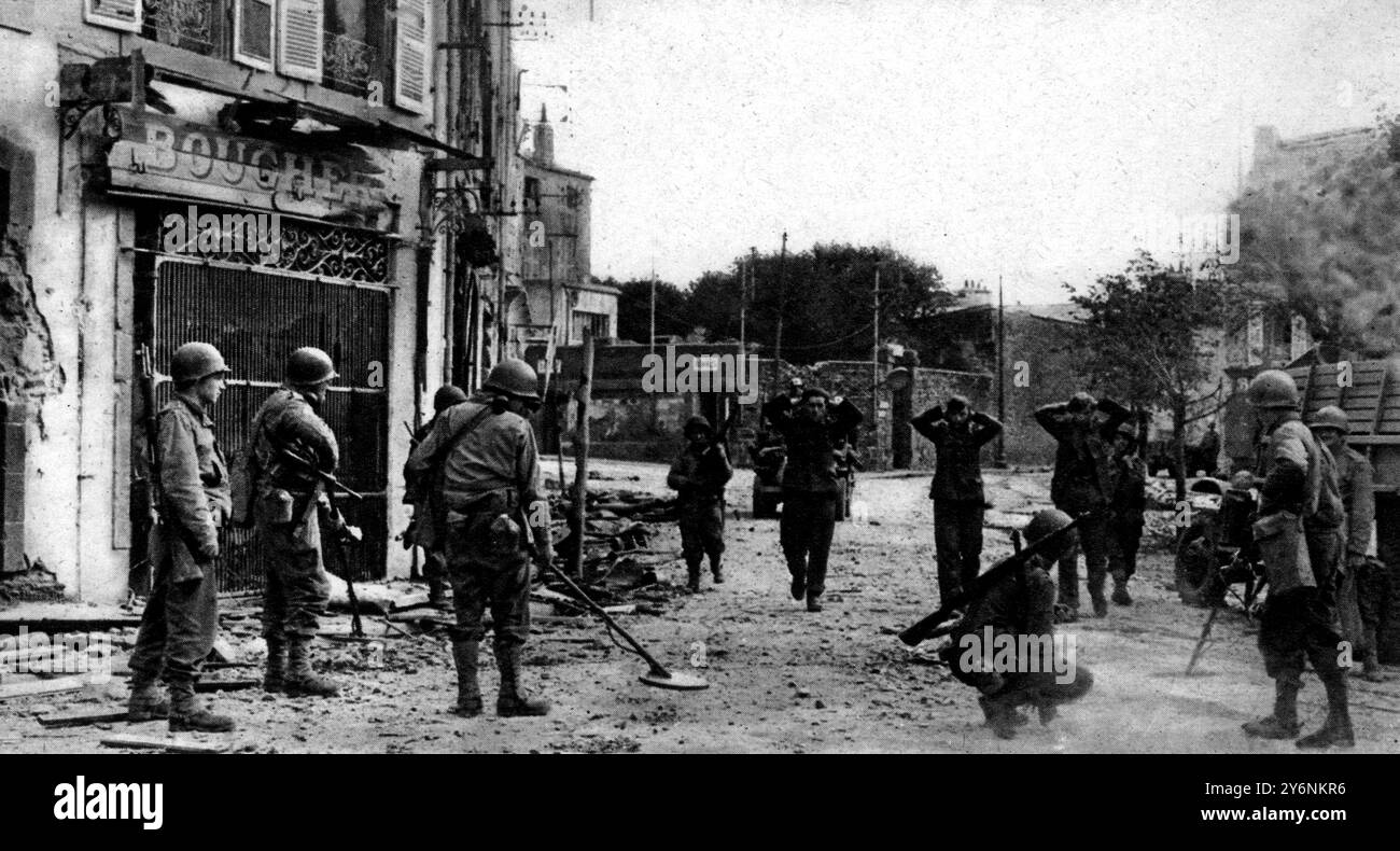 An American patrol, bringing back German prisoners, passes a group of ...