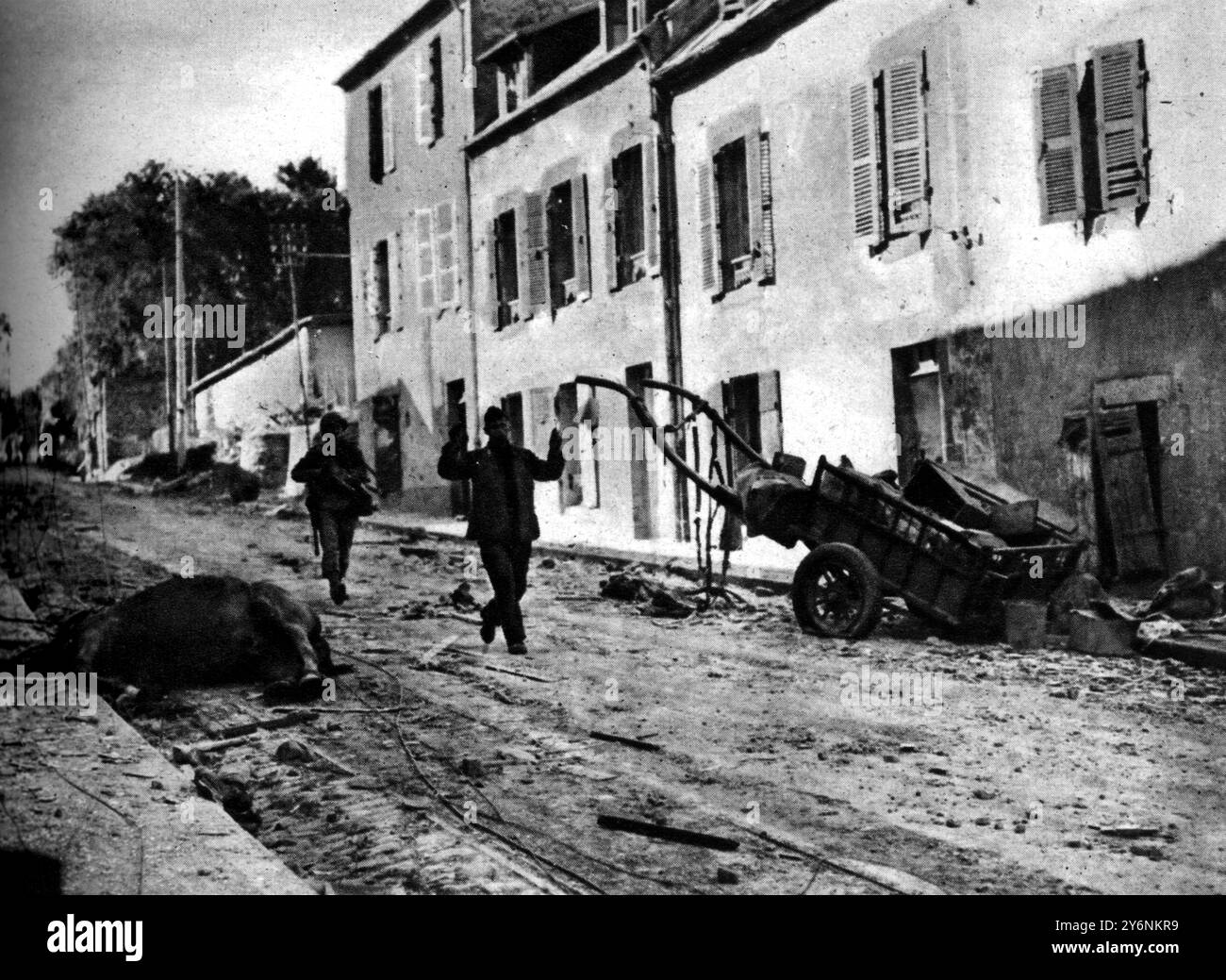 A German sniper being marched down a street in Brest where even small ...