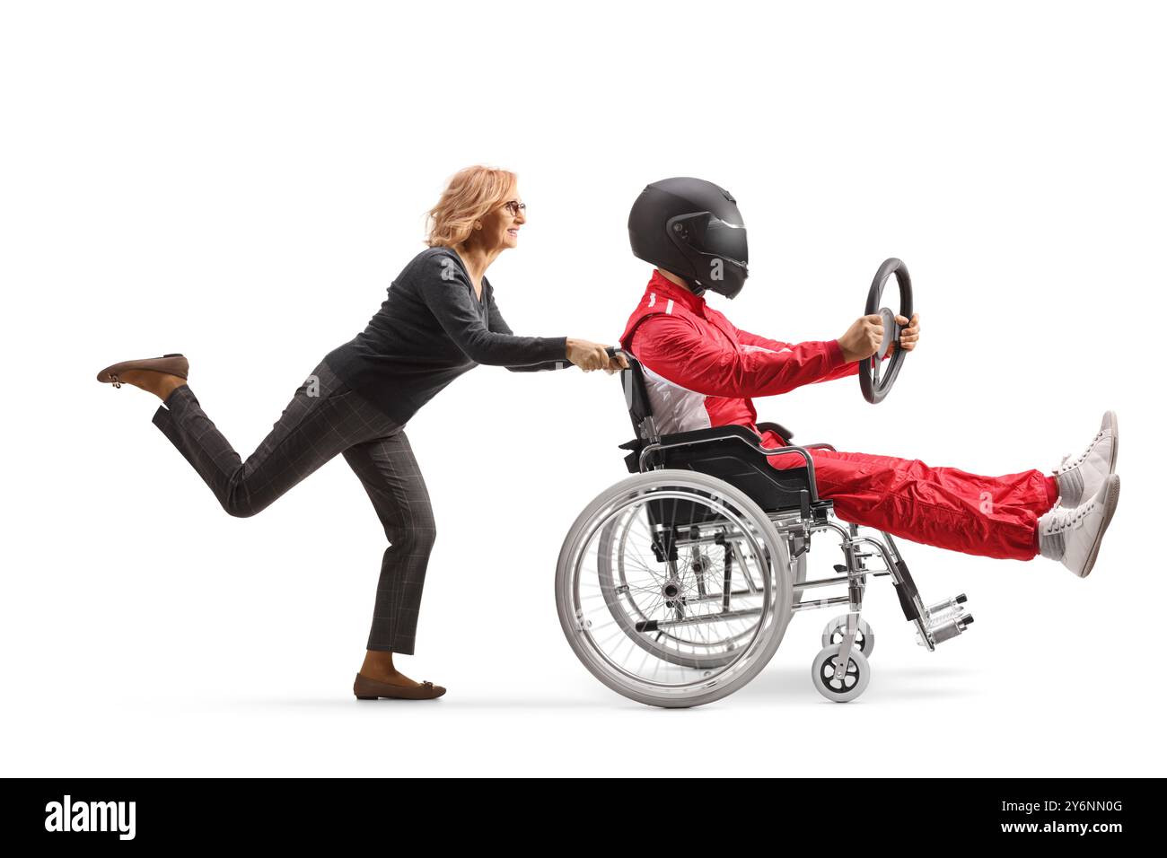 Woman pushing a car racer with helmet in a wheelchair isolated on white ...