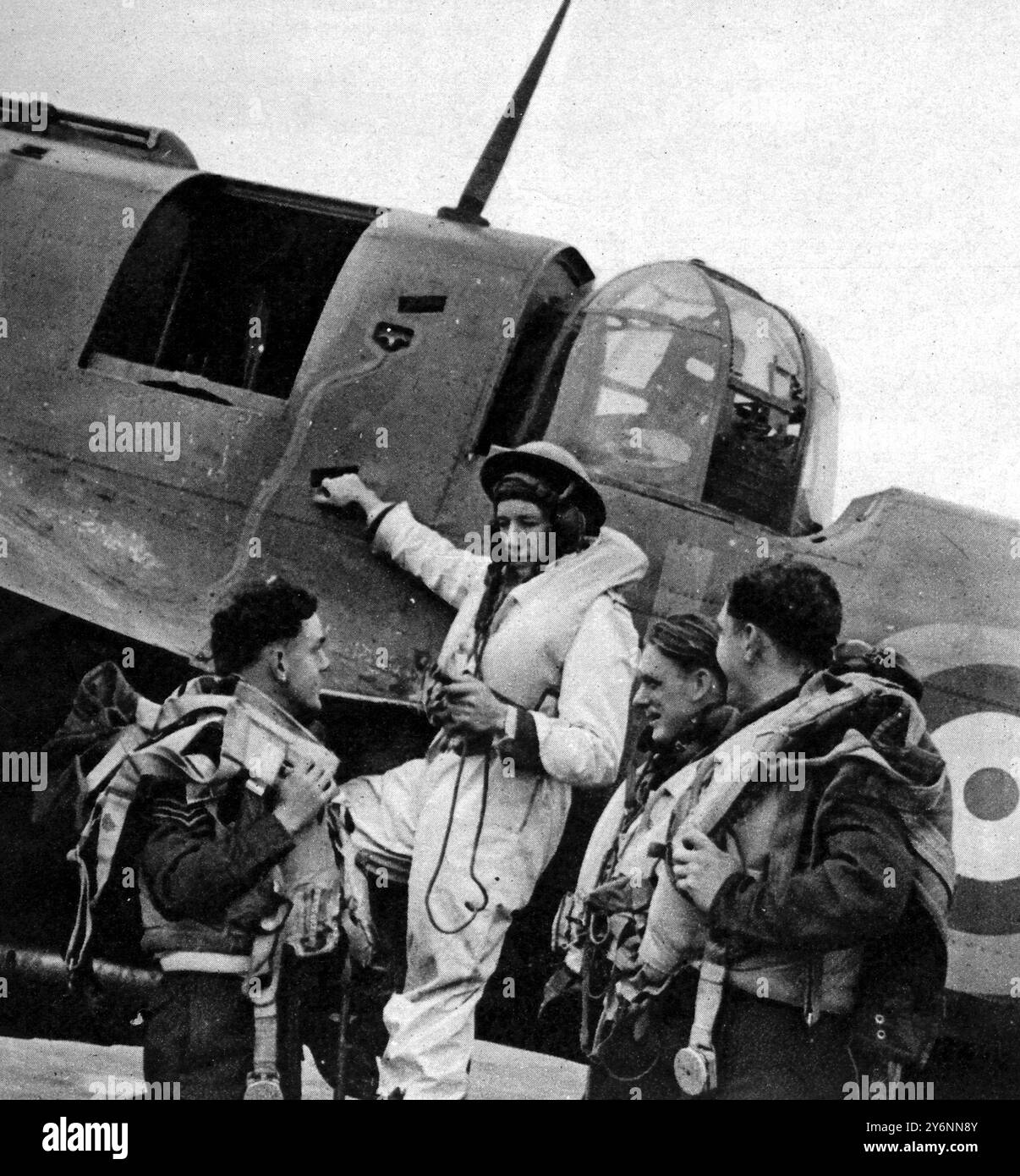 The captain and crew of a Beaufort. The pilot is wearing a tin hat to ...