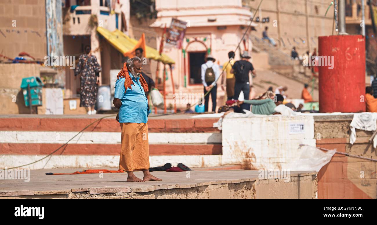 Varanasi, Uttar Pradesh, India. Man standing on Kshemeshvar ghat steps ...