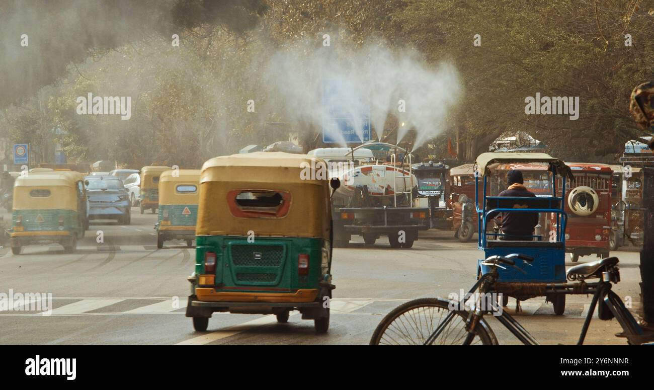 New Delhi, Delhi, India. Fire truck spraying water over Delhi streets ...
