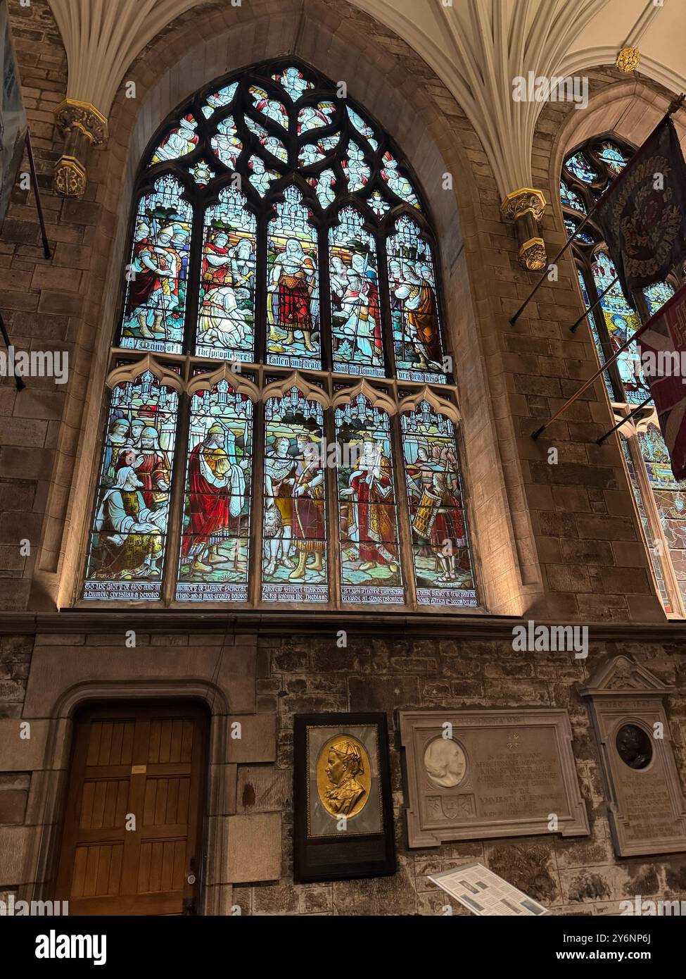 A stained glass window depicting historical scenes inside Edinburgh ...