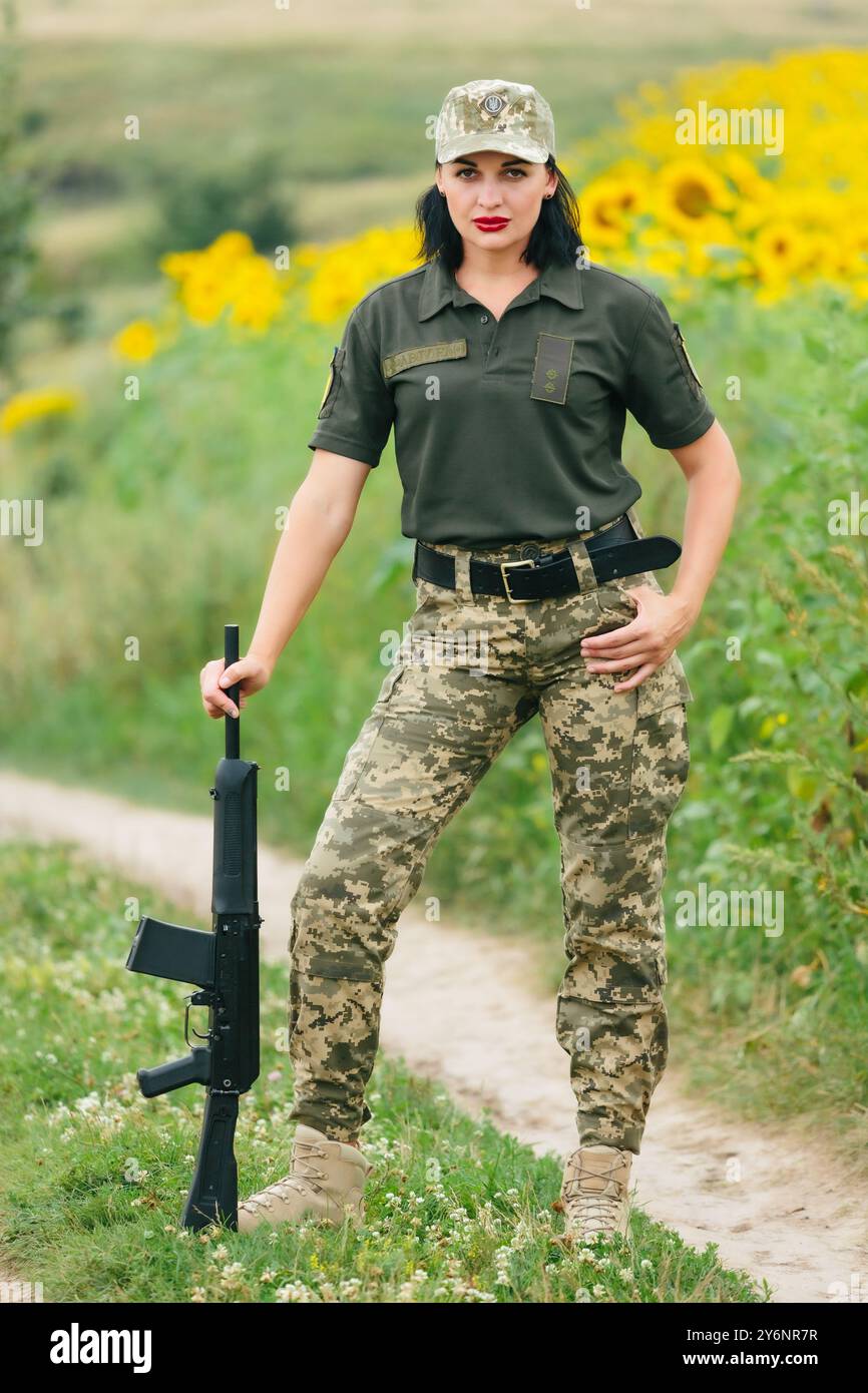 Soldier woman in military uniform. A girl in a military uniform with a ...
