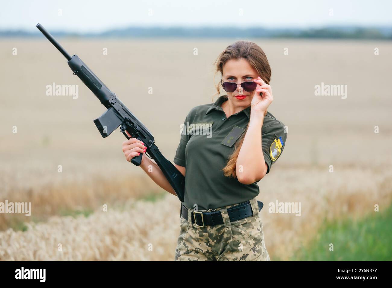Soldier woman in military uniform. A girl in a military uniform with a ...