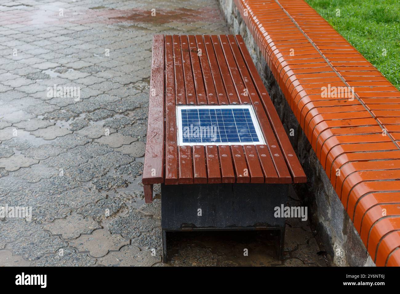 A bench with a built-in solar panel for charging phones Stock Photo - Alamy