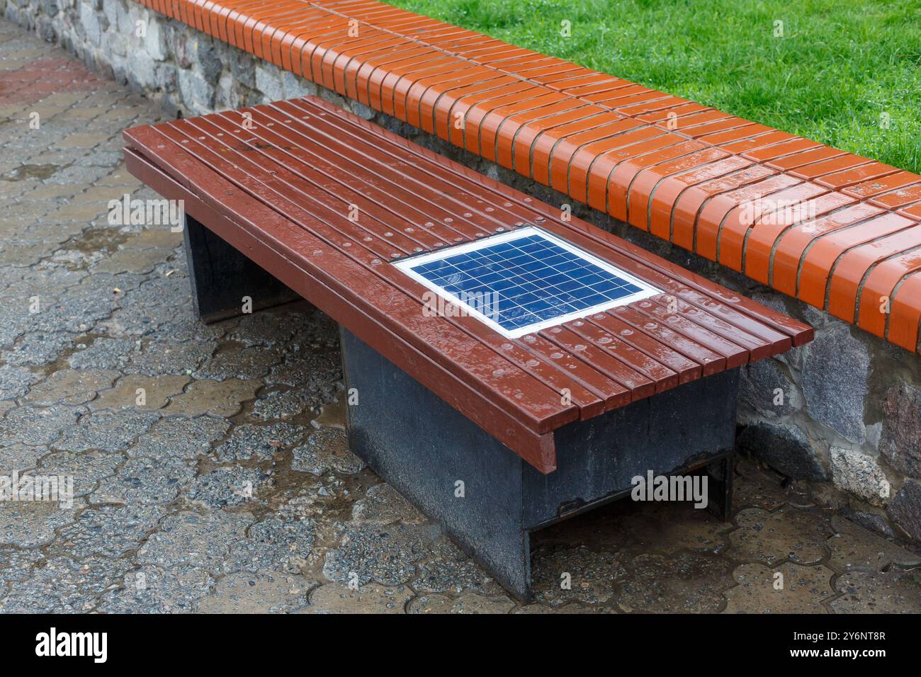 A bench with a built-in solar panel for charging phones Stock Photo - Alamy