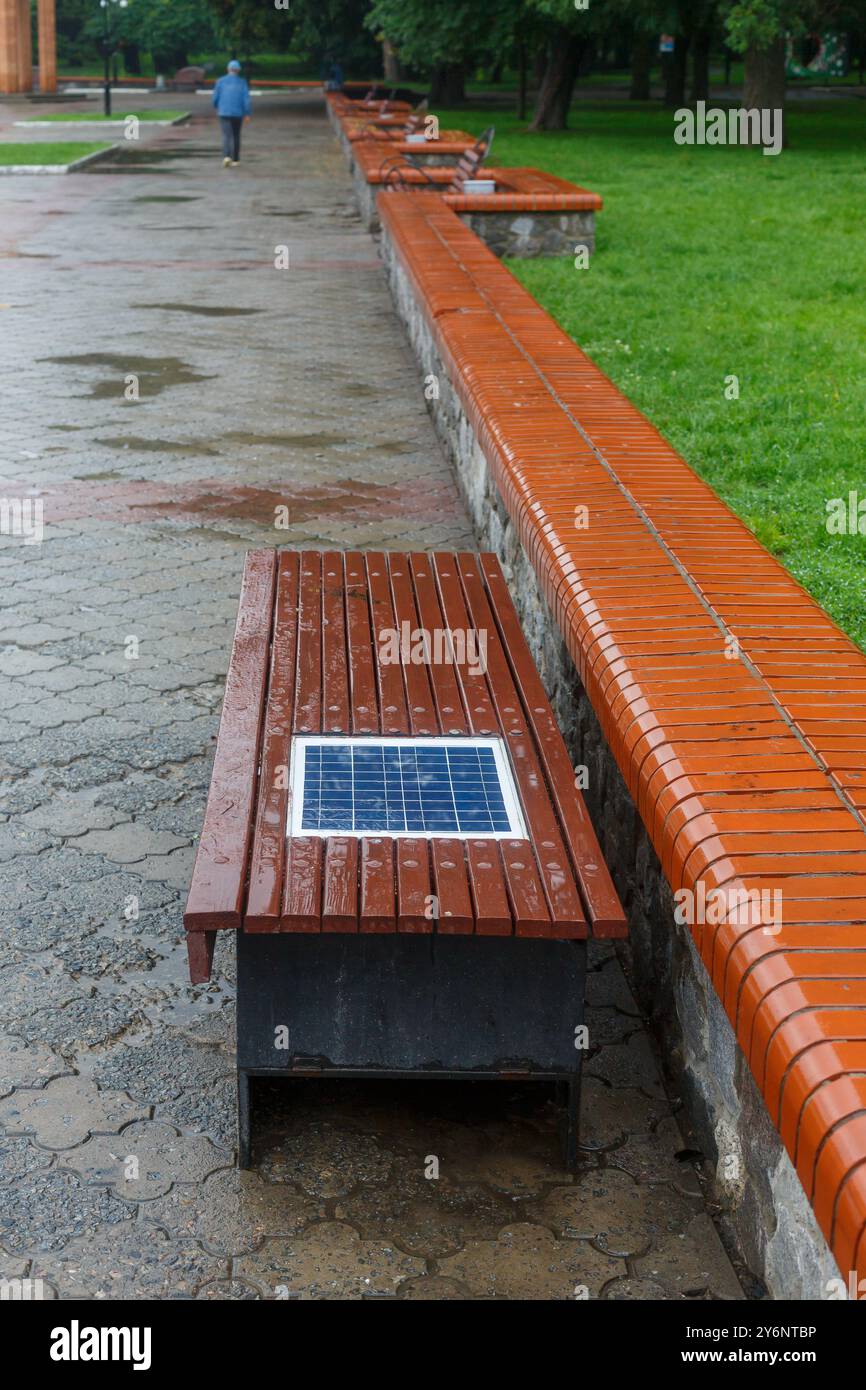 A bench with a built-in solar panel for charging phones Stock Photo - Alamy