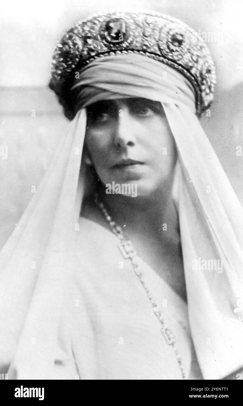 The Queen of Rumania wearing a striking head-dress. She is at present ...