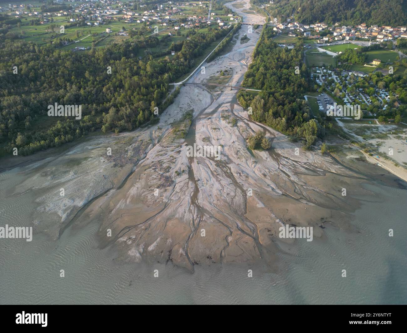 Aerial view of a river delta with surrounding greenery and residential ...