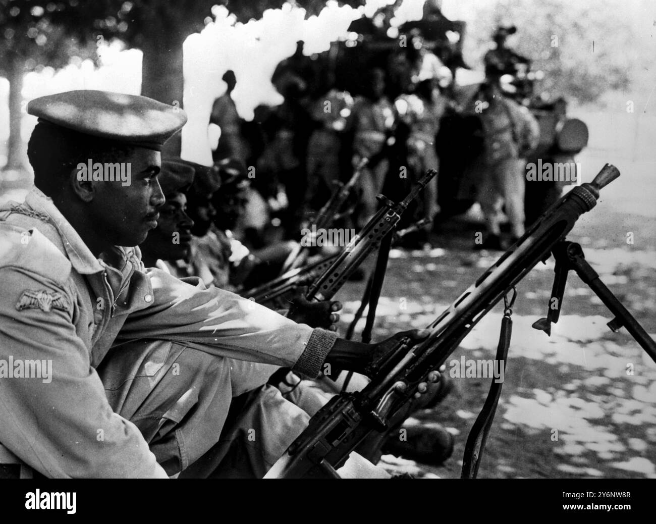 Khartoum, Sudan: Machine gun at the ready, Sudanese troops squat in a ...