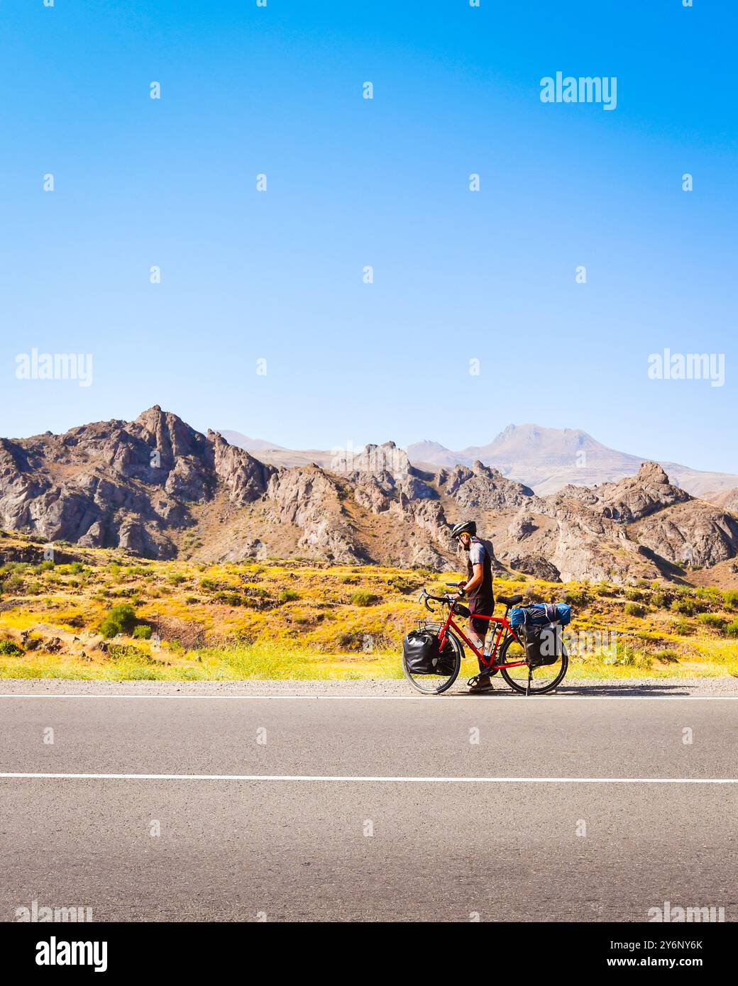 Solo cyclist stop on road with bicycle check map being lost outdoors in ...