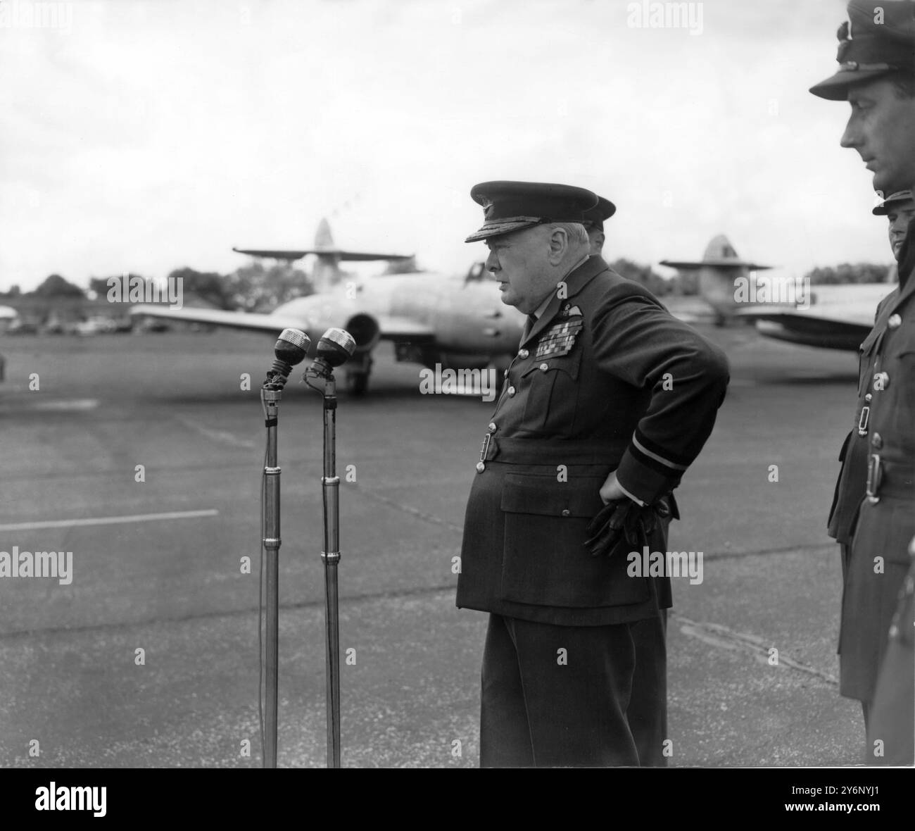 Winston Churchill in Air Commodore's uniform stands hand on hip as he addresses 615 ( County of ...