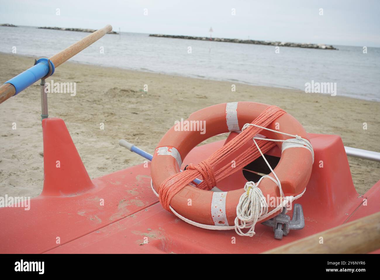 Safety boat with lifesaver. Sand and sea background Stock Photo - Alamy
