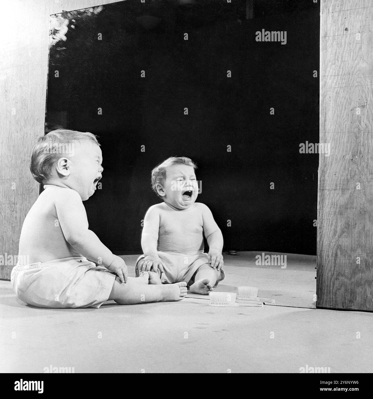 Baby Crying In Front Of Mirror Stock Photo - Alamy