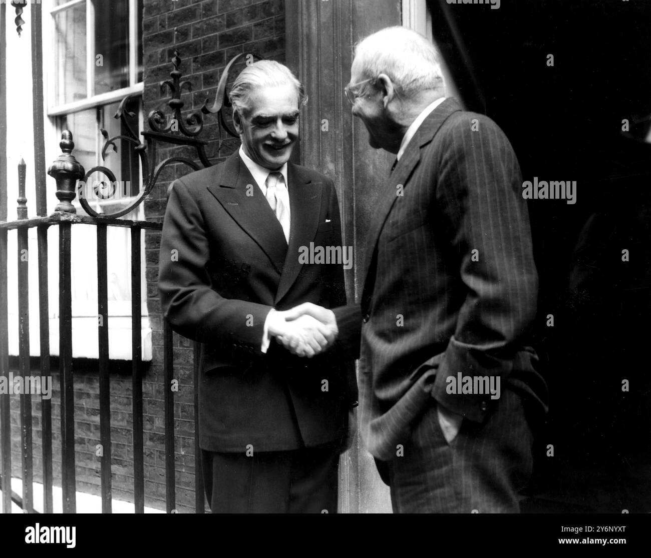 Mr John Foster Dulles, US Secretary of State, is shown shaking hands ...