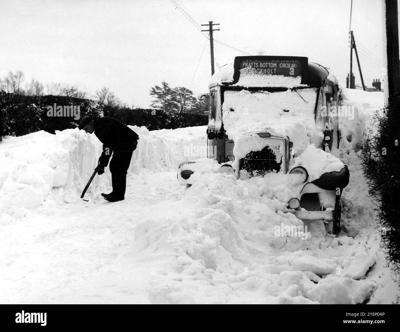 Snow up on the roof of this bus at Cudham, Kent. Two other buses ...