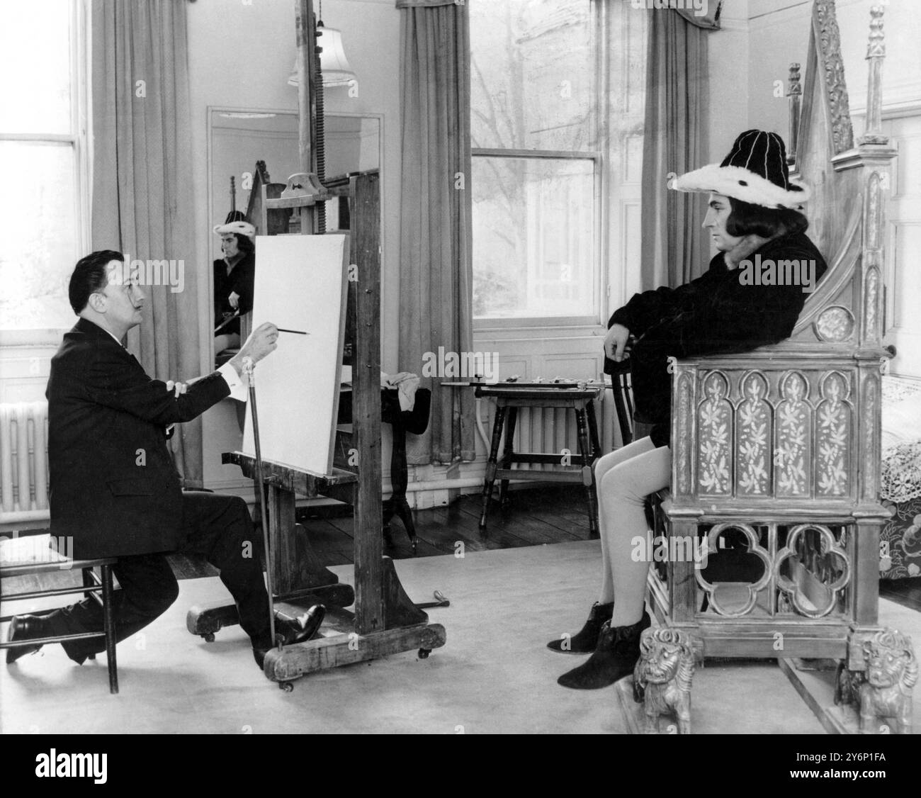 Flamboyant surrealist painter Salvador Dali works on a painting of ...