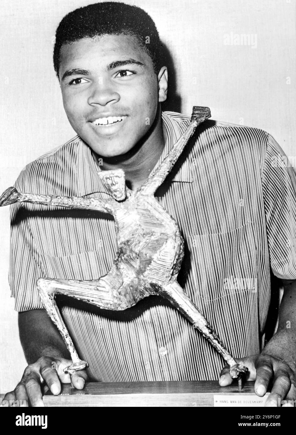 Cassius Clay the World's New Heavyweight Champion poses with bronze ...