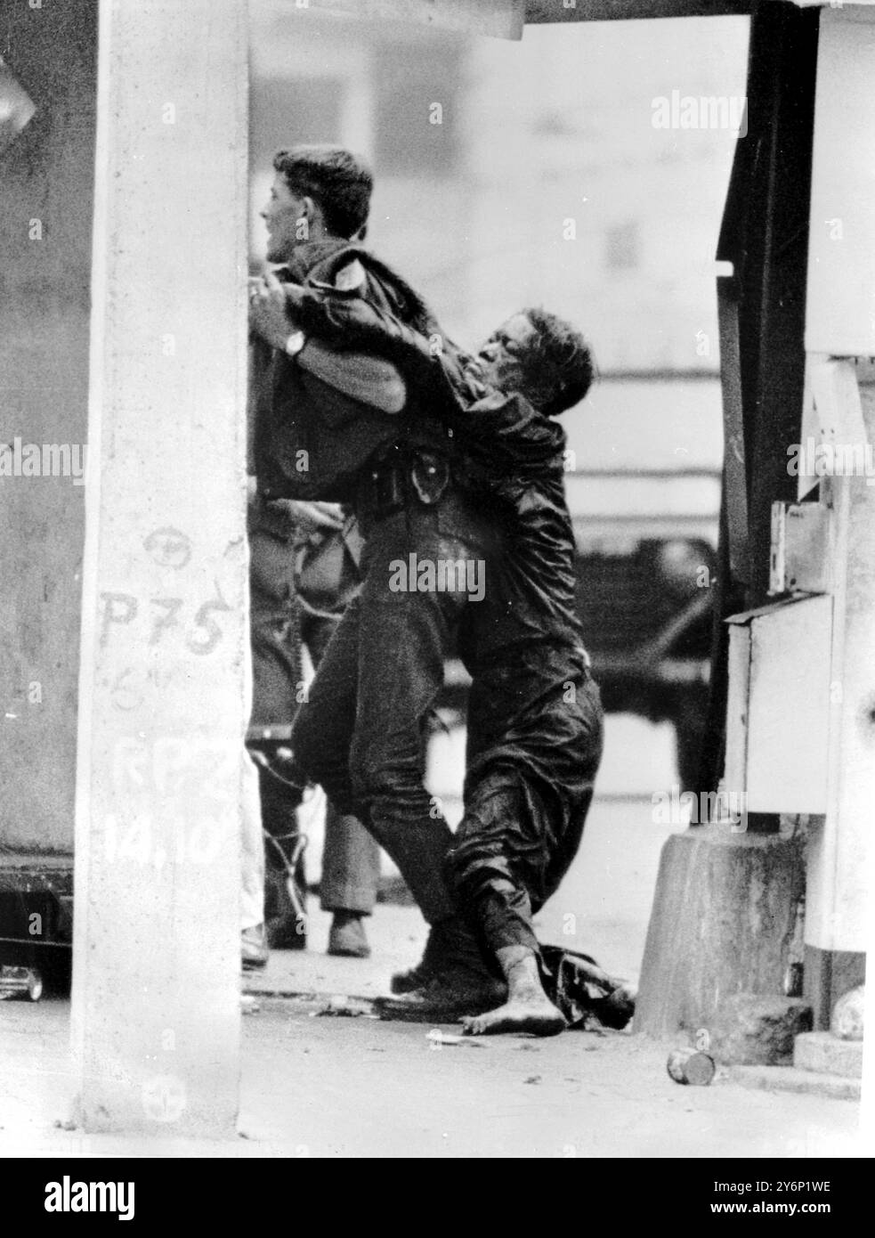 An American soldier pulls a Vietnamese civilian to safety after ...