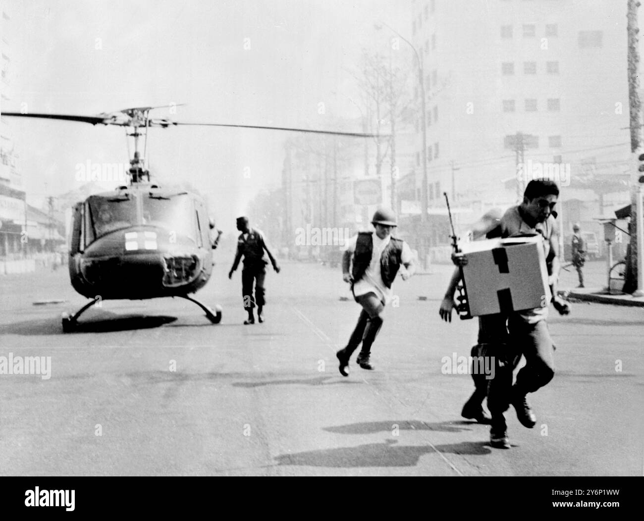 4 February 1968: Siagon, South Vietnam. An American trooper runs toward ...