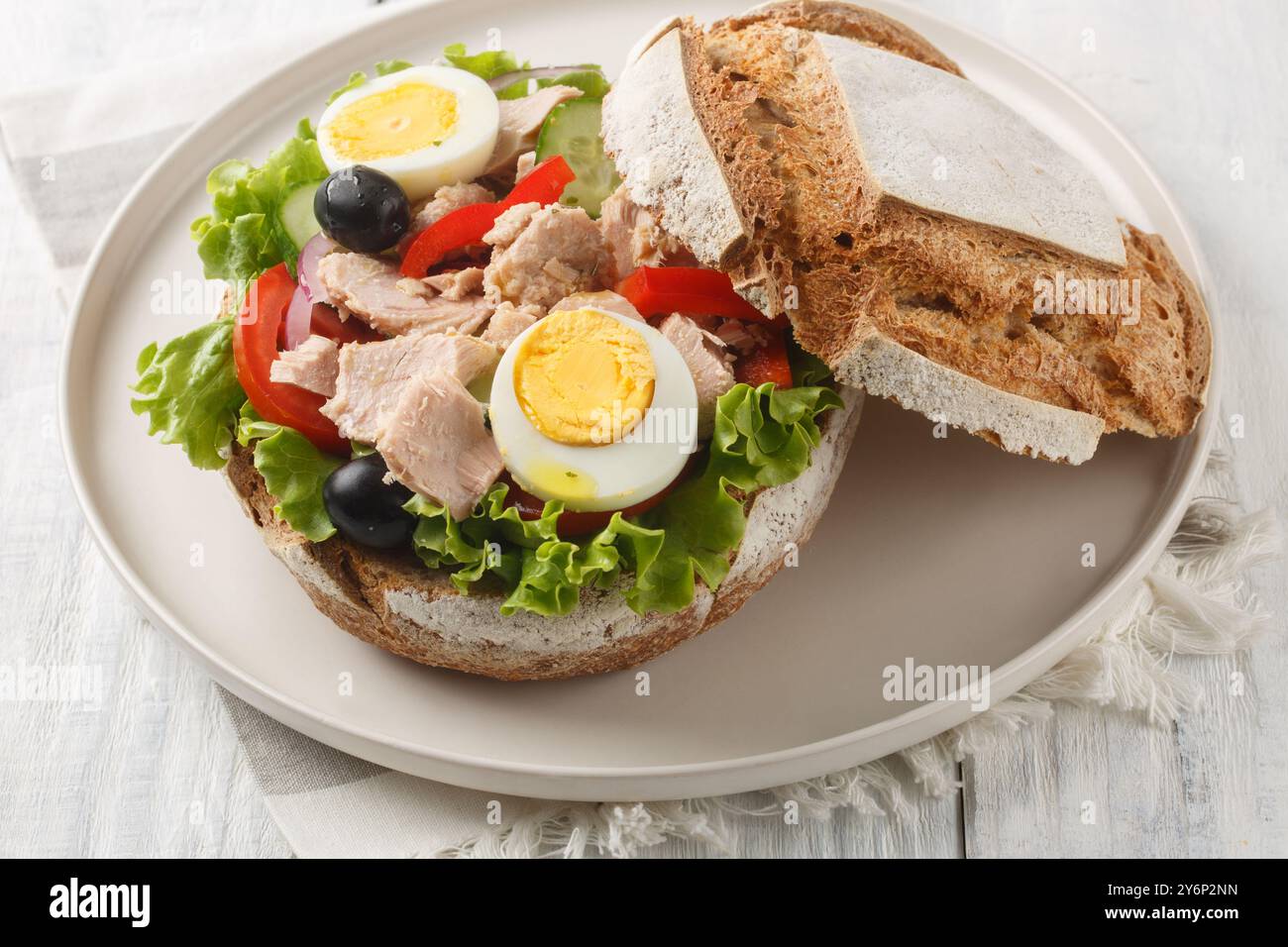 French Pan Bagnat sandwich with salad nicoise consisting of hard-boiled ...